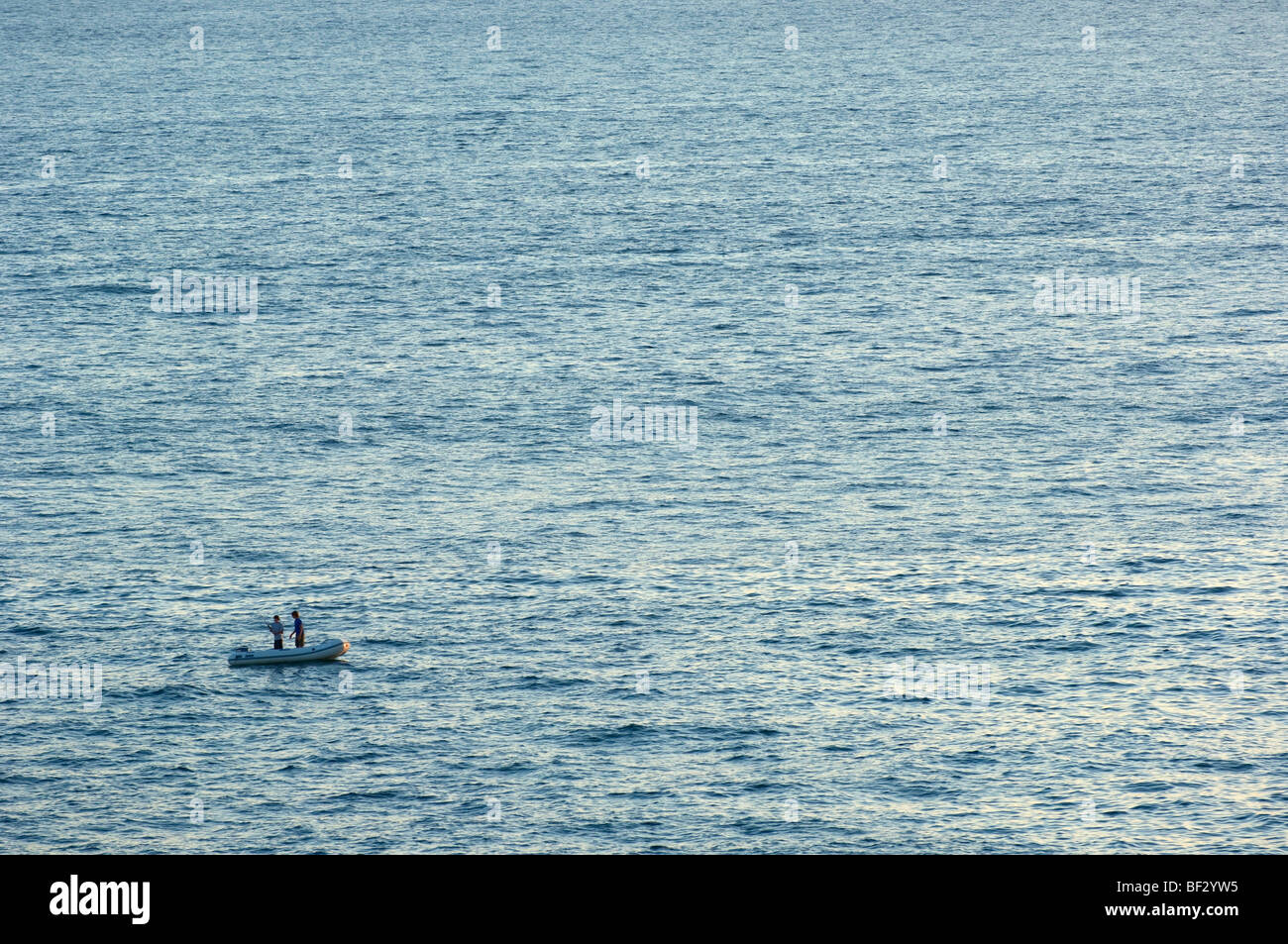 Big ocean, tiny boat. Two people go fishing in the Pacific ocean using ...