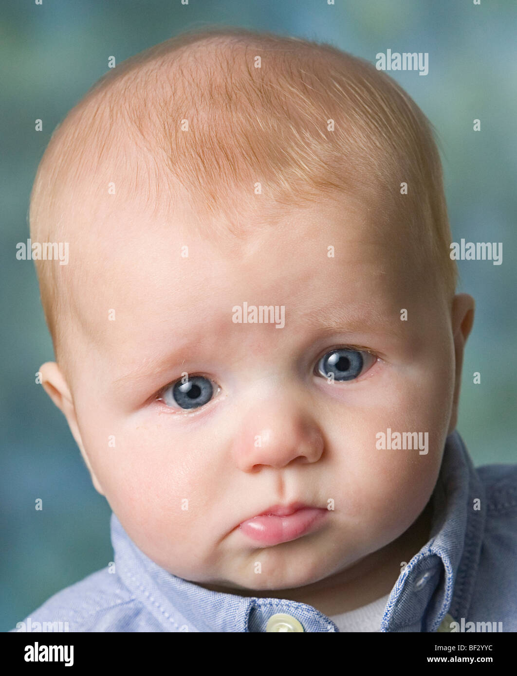portrait of a toddler looking worried Stock Photo - Alamy