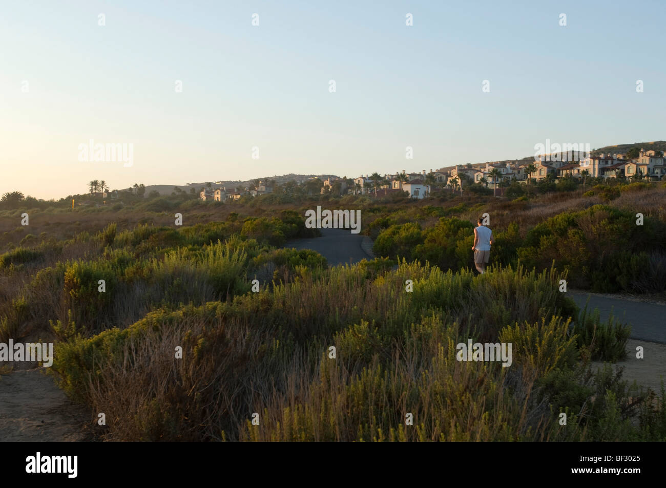 Man running along the a trail overlooking the ocean in Corona Del Mar ...