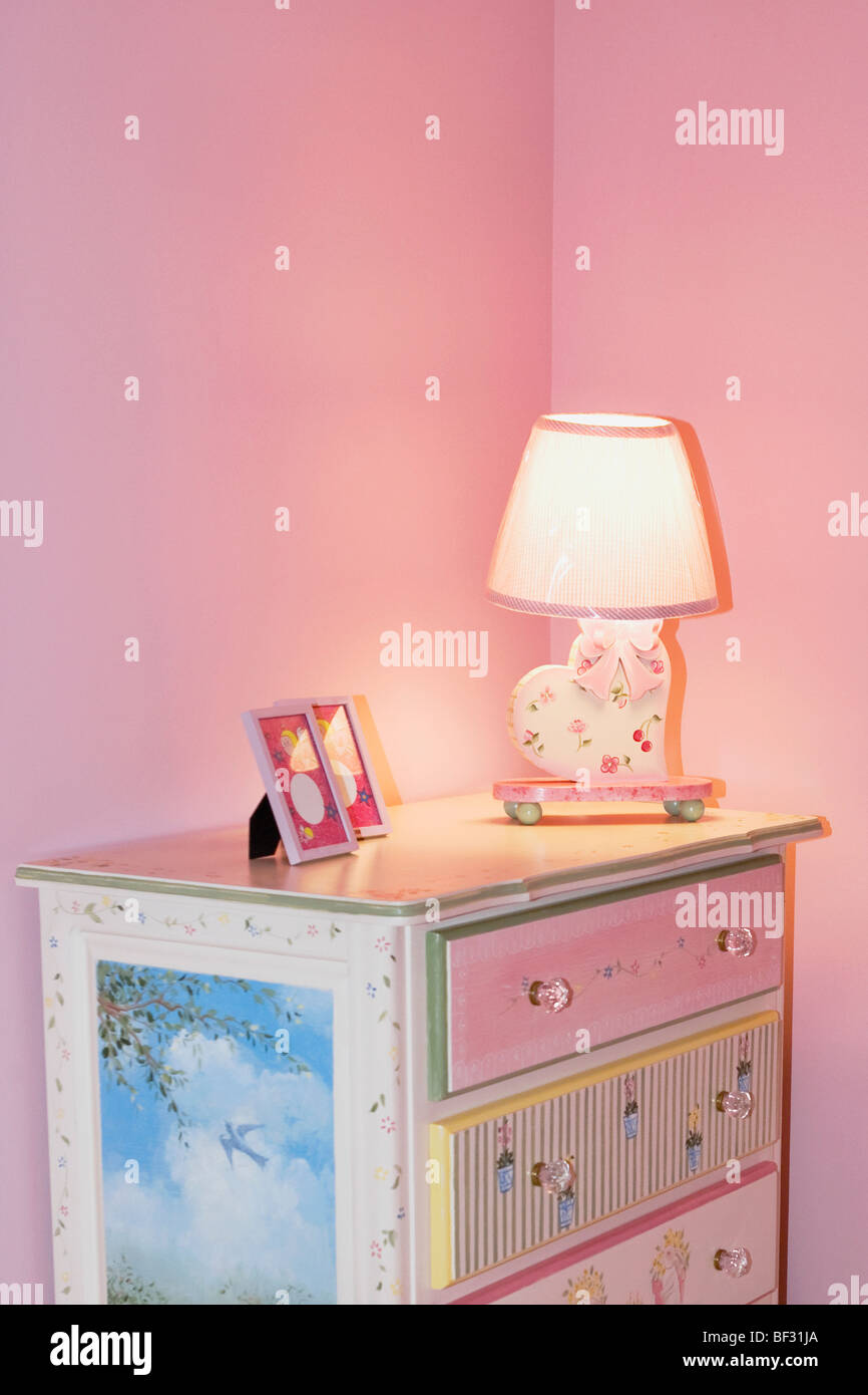 Lamp with a picture frame on a sideboard Stock Photo - Alamy