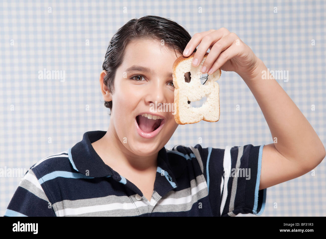 Boy holding a slice of bread Stock Photo - Alamy