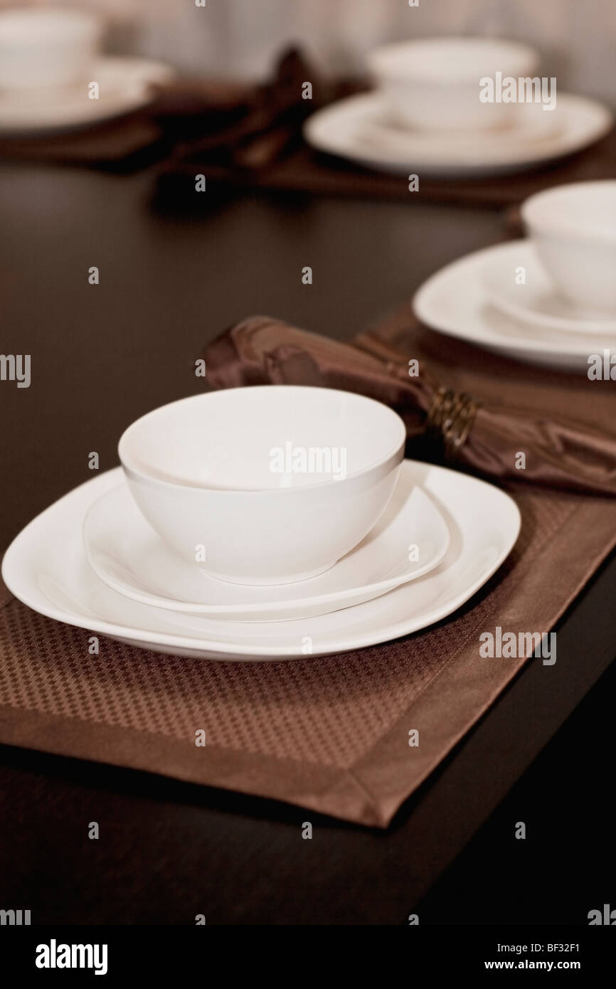 Bowl and plates on a dining table Stock Photo - Alamy