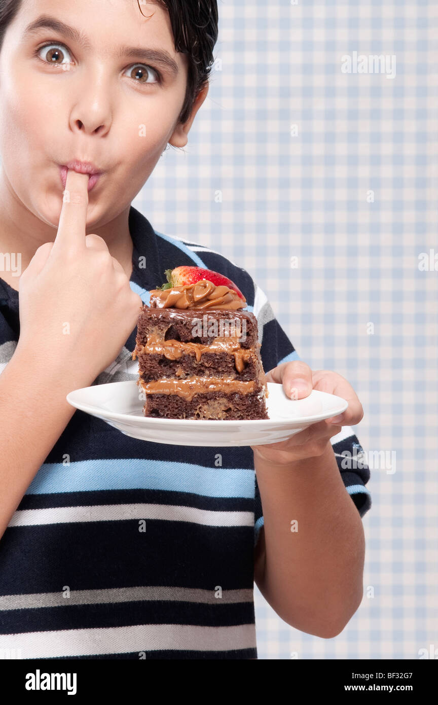 Boy eating a chocolate cake Stock Photo - Alamy
