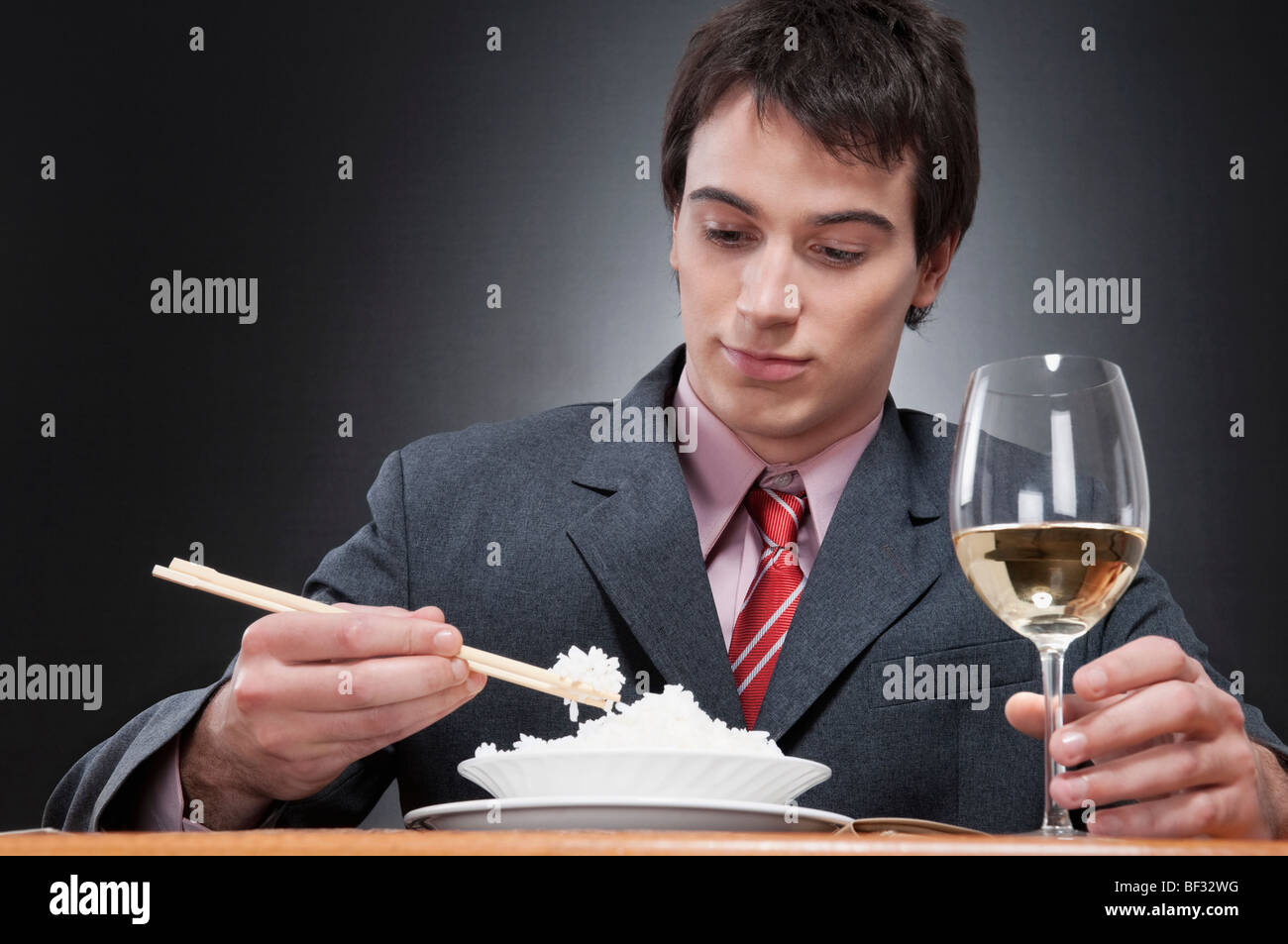 Close-up of a businessman eating rice with chopsticks Stock Photo - Alamy