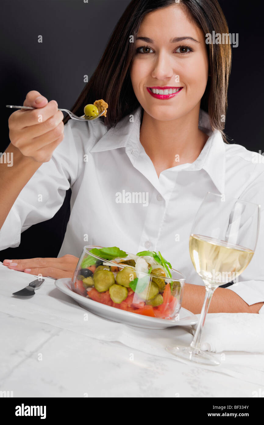 Woman eating salad and smiling Stock Photo - Alamy