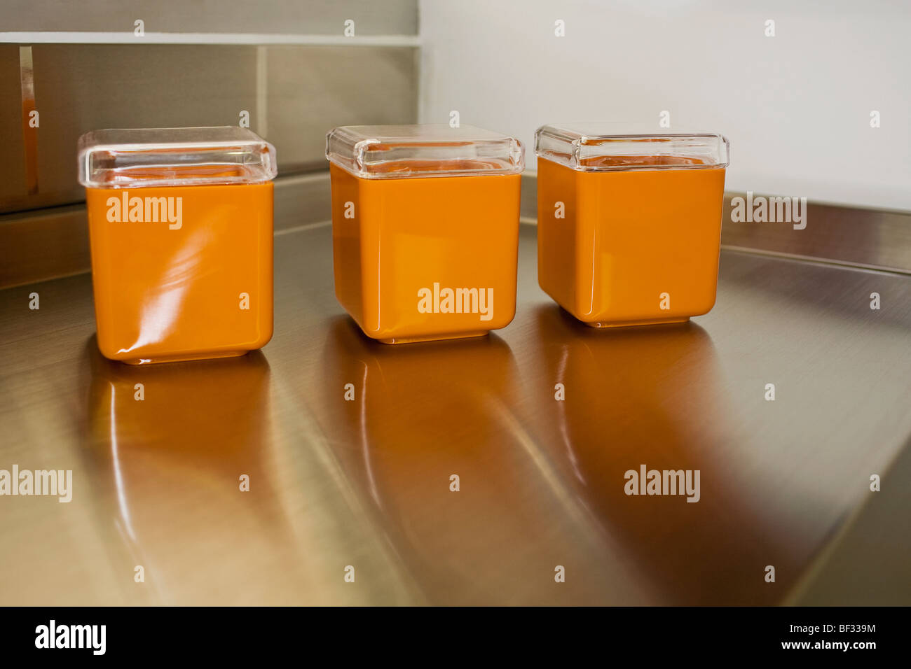 Three containers on a table Stock Photo - Alamy