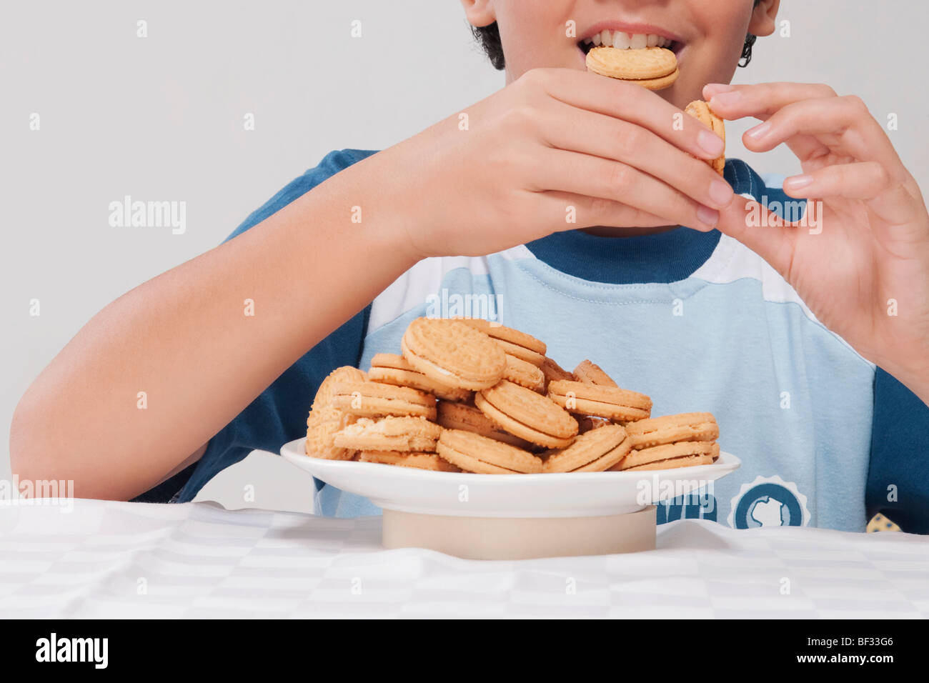 Close-up of a boy eating cookies Stock Photo - Alamy