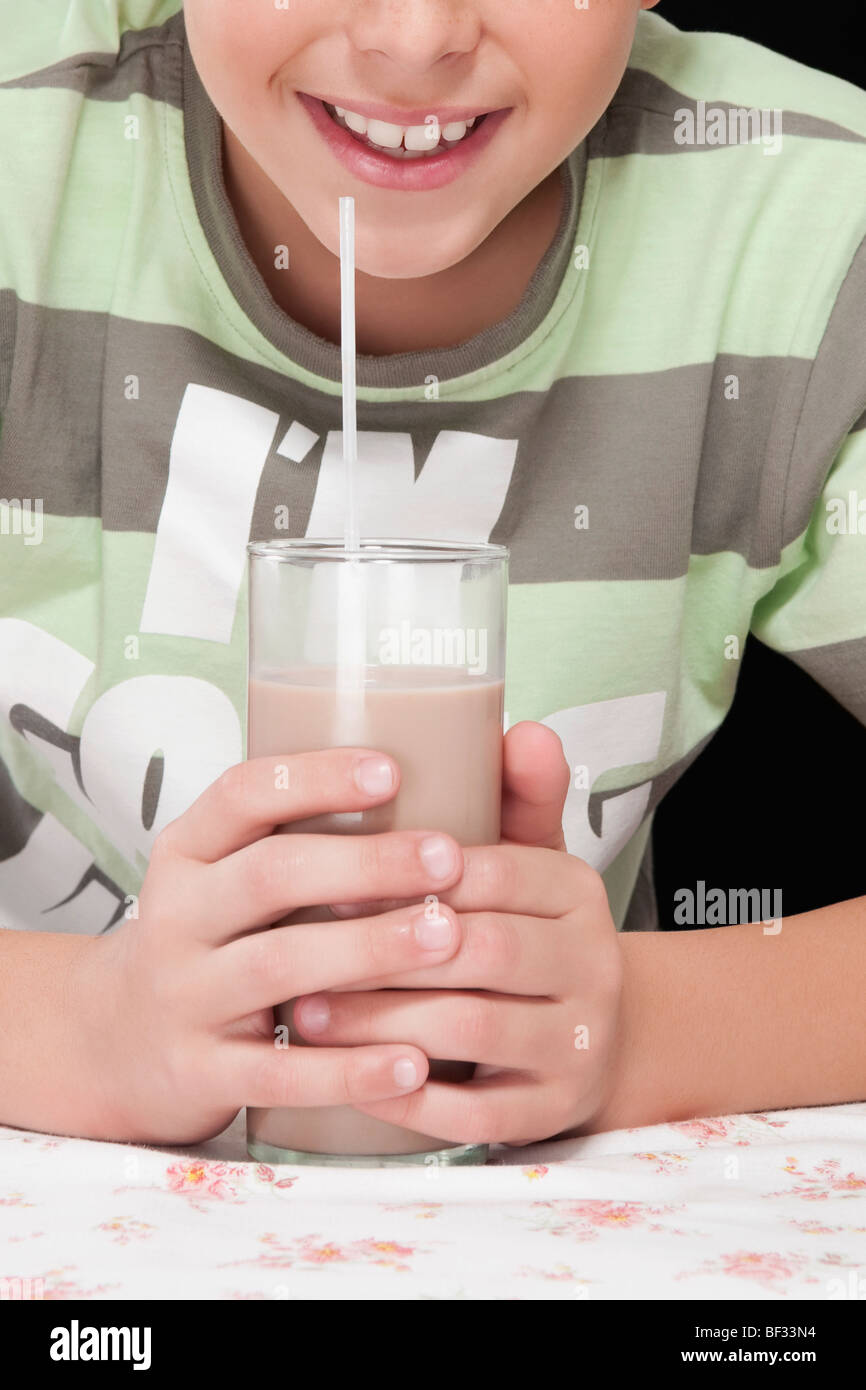 Boy drinking chocolate milkshake and smiling Stock Photo - Alamy