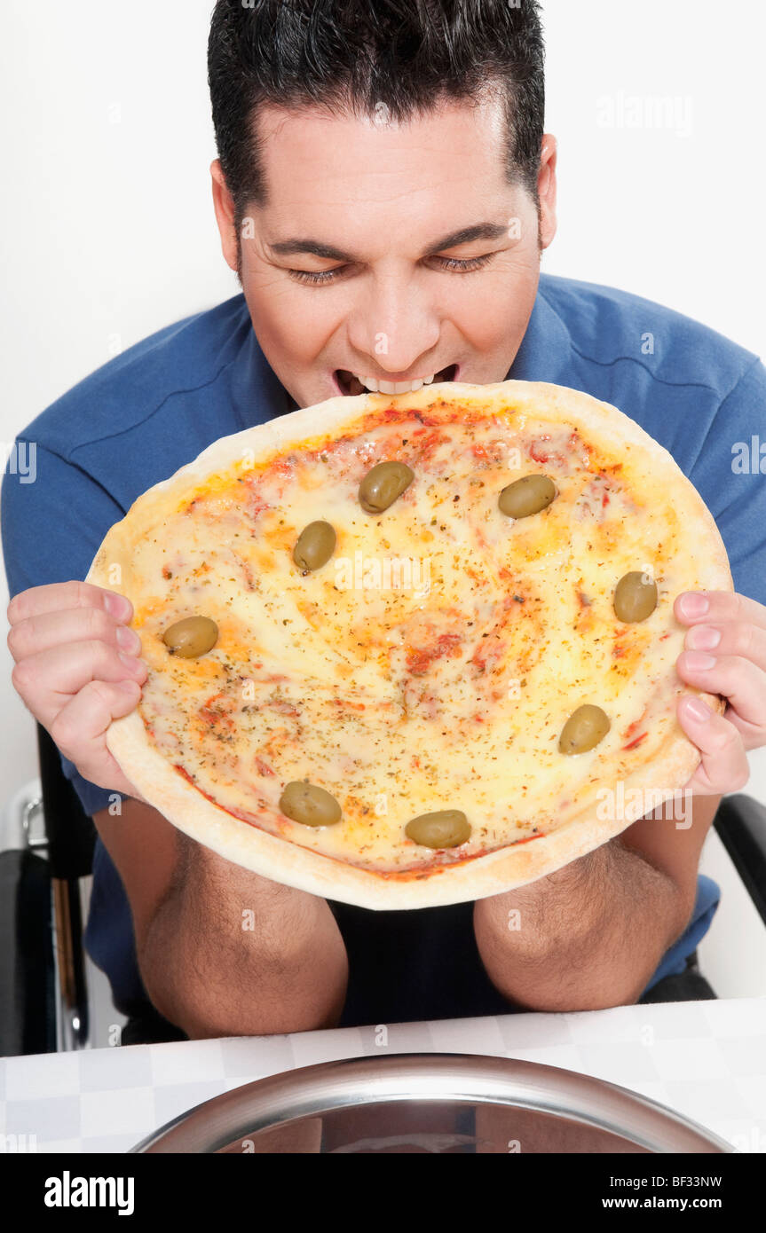 Man eating a pizza pie Stock Photo - Alamy