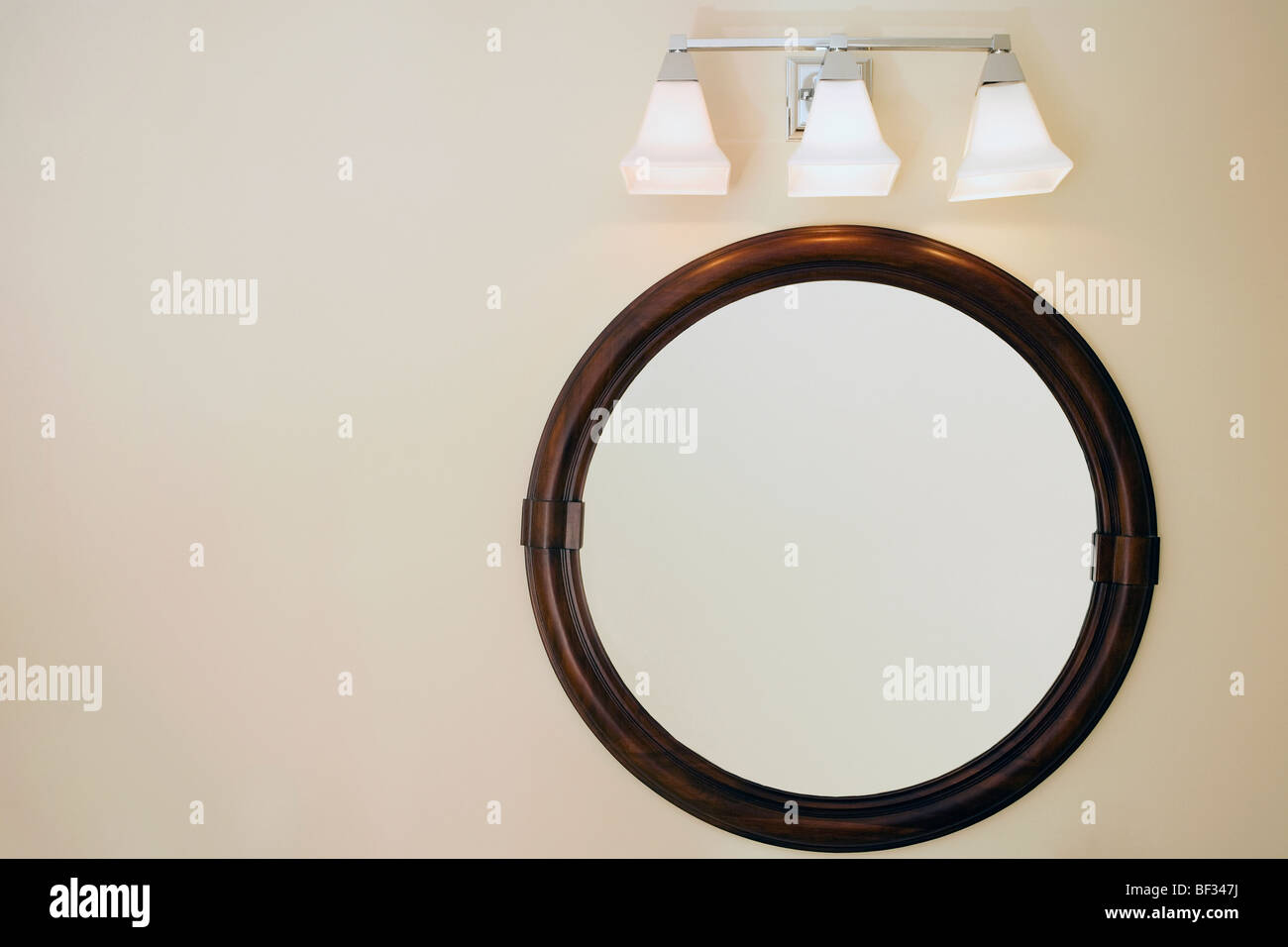 Lamp lit up over a bathroom mirror Stock Photo - Alamy