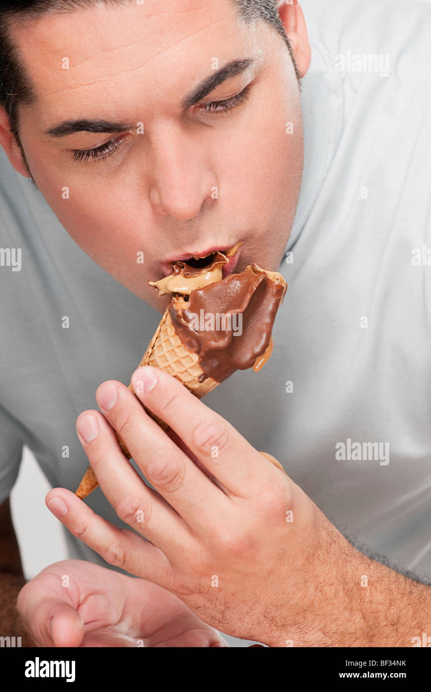 Close-up of a man eating an ice cream cone Stock Photo - Alamy