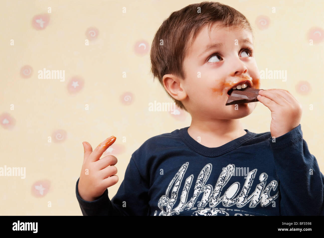 Boy eating a chocolate bar Stock Photo - Alamy