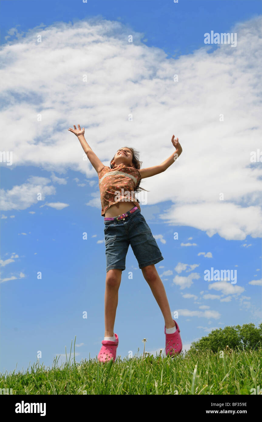 Young girl jumping outdoors Stock Photo - Alamy