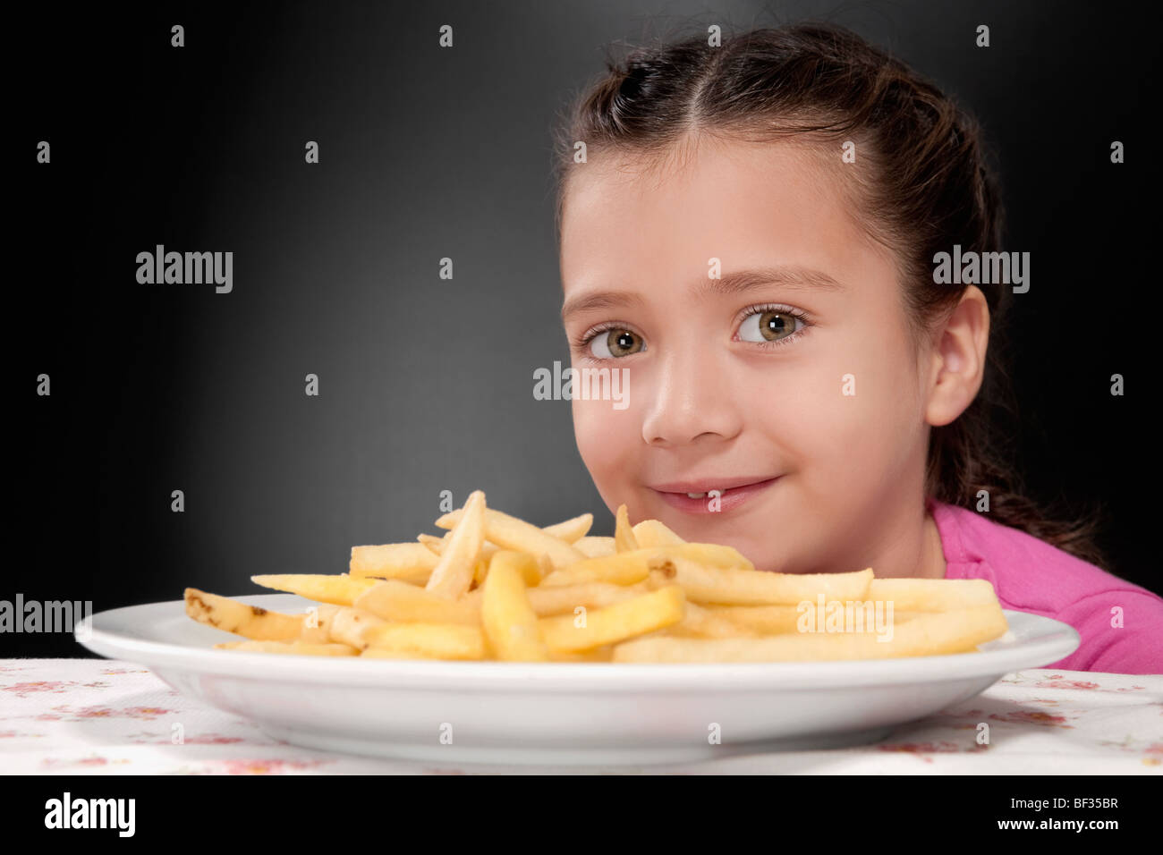 Portrait of a girl with French fries Stock Photo - Alamy