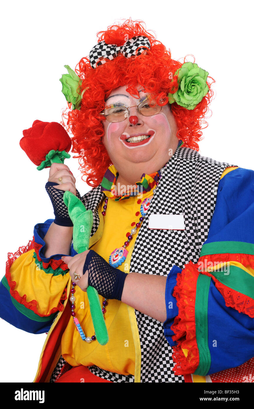 Clown with orange hair holding prop rose Stock Photo - Alamy