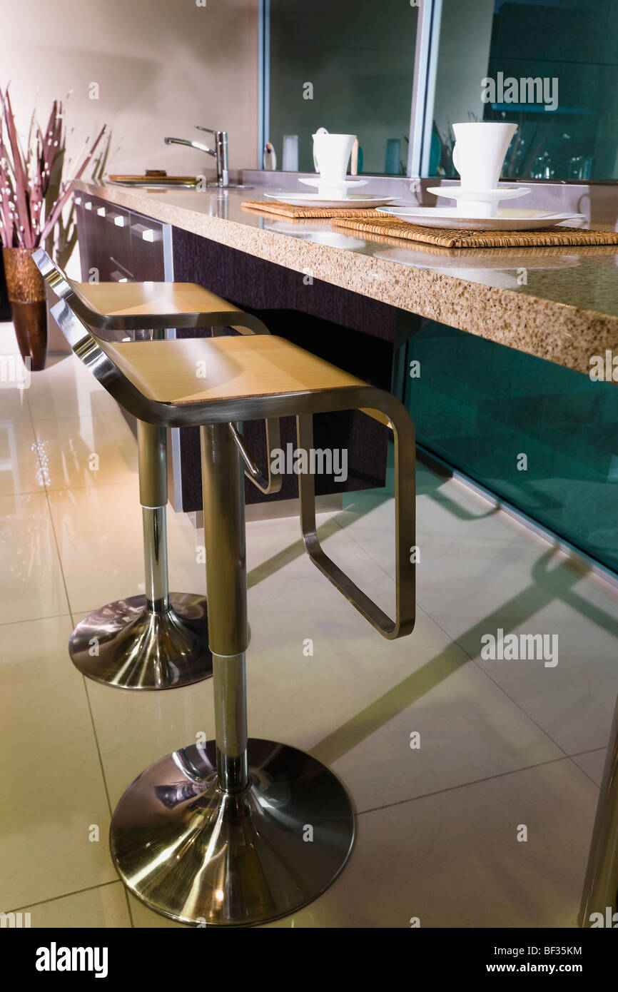 Chairs near a kitchen counter Stock Photo - Alamy