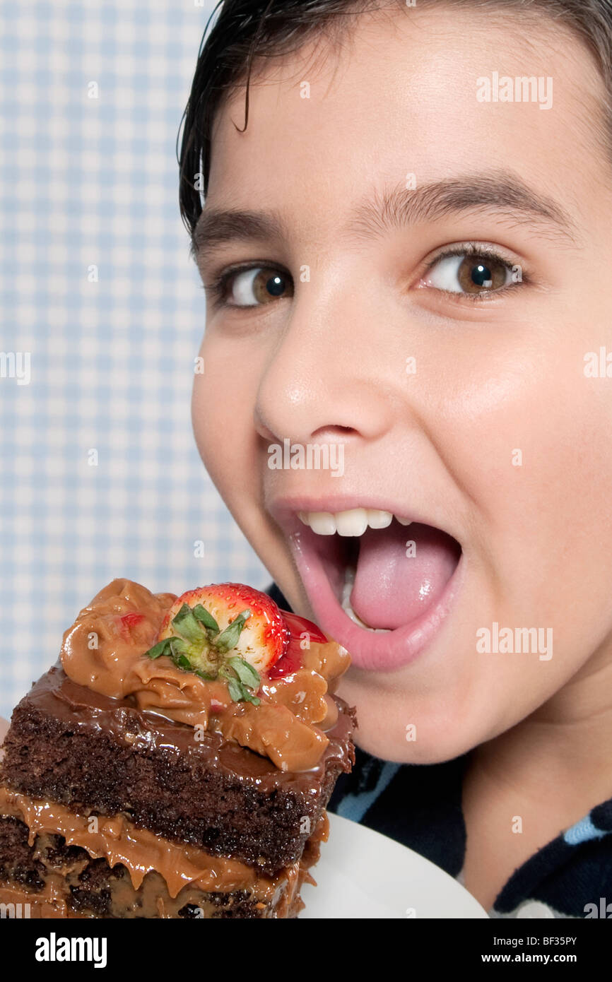 Boy eating a chocolate cake Stock Photo - Alamy