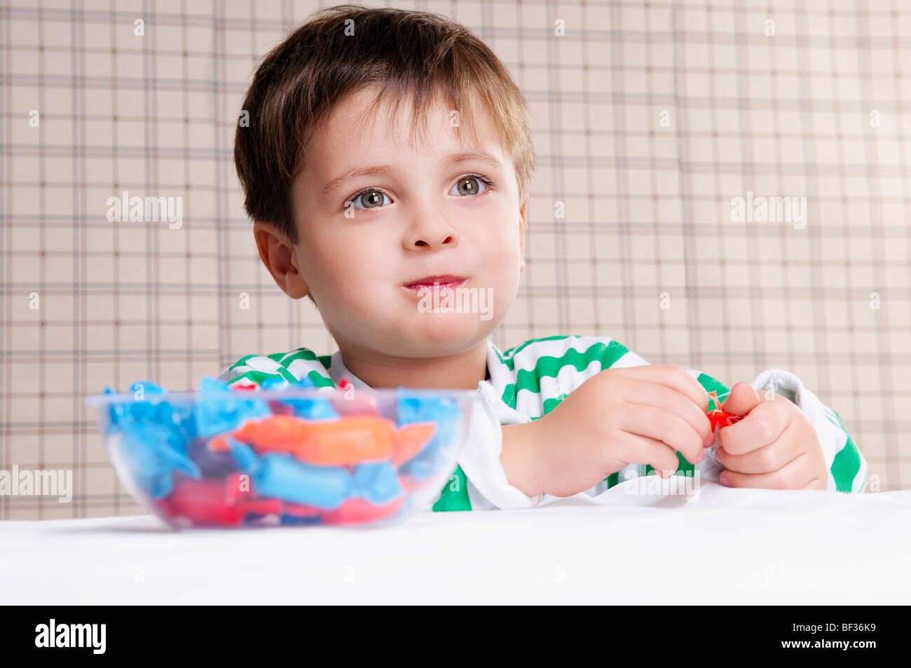 Close-up of a boy eating a candy Stock Photo - Alamy