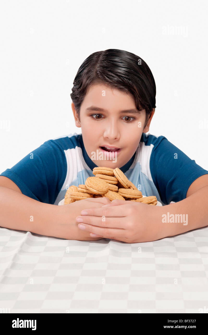 Close-up of a boy hugging a plate of cookies Stock Photo - Alamy