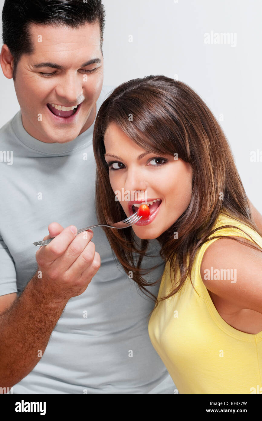 Man feeding cherry to a woman Stock Photo - Alamy