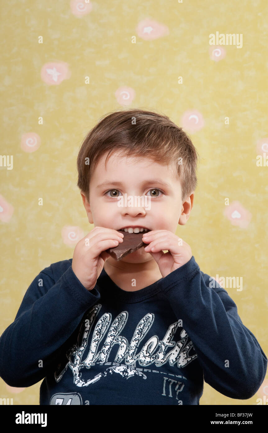 Boy eating a chocolate bar Stock Photo - Alamy