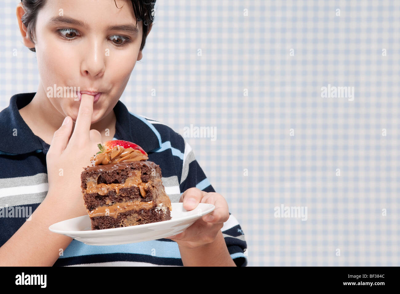 Boy eating a chocolate pastry Stock Photo - Alamy