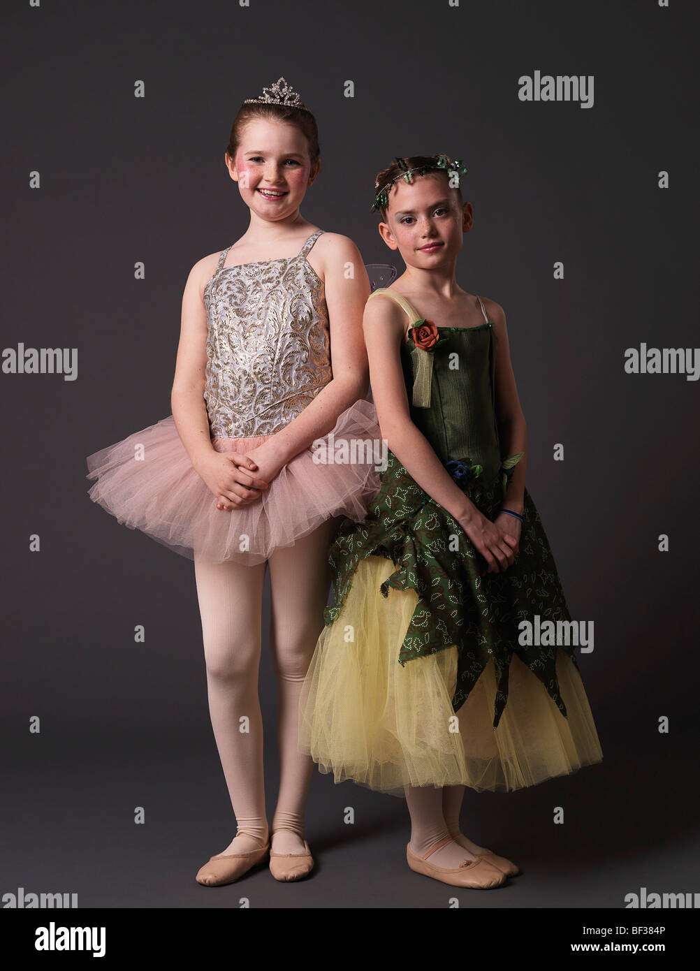 Two girls standing side by side Stock Photo - Alamy