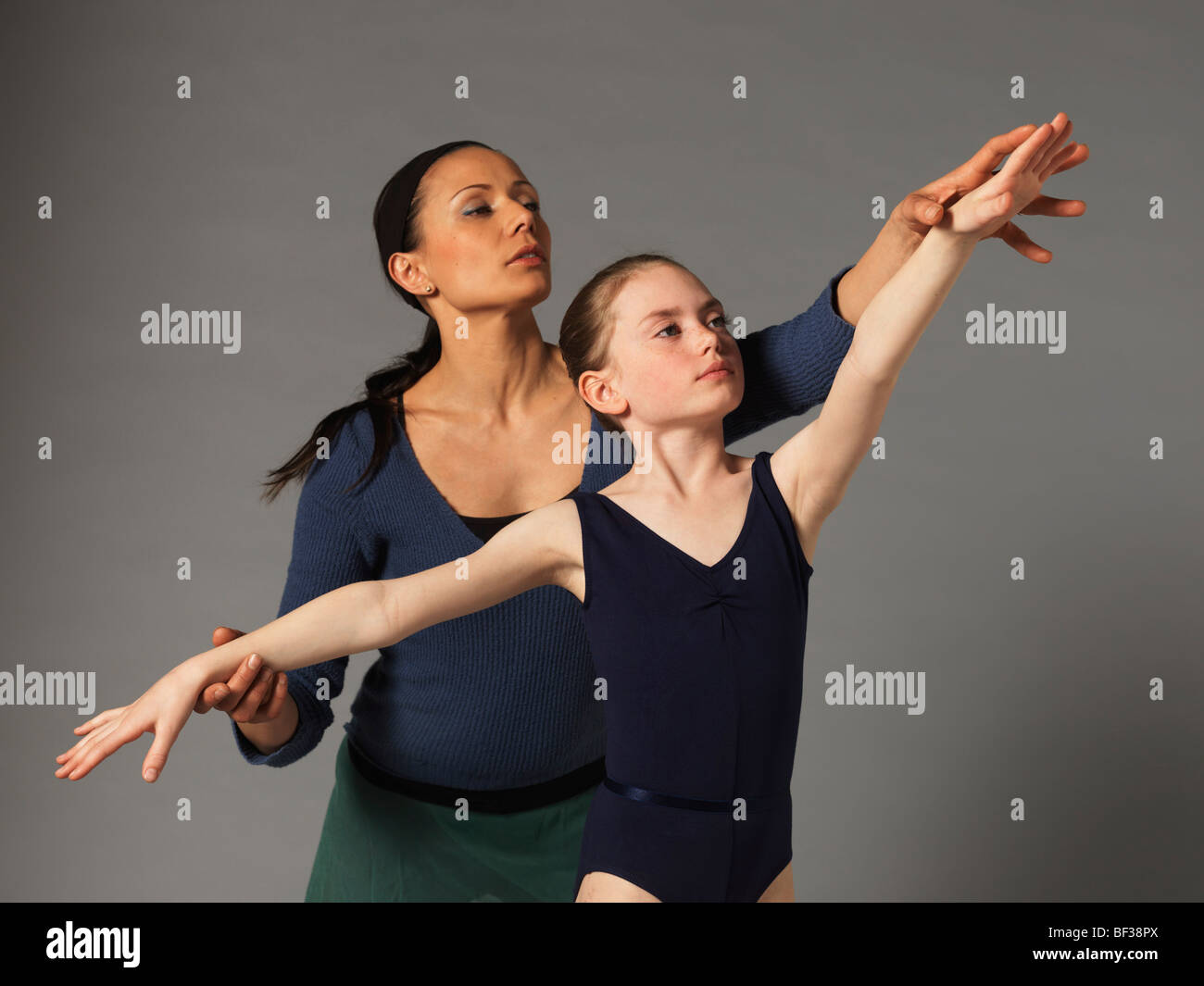 Woman teaching girl a pose Stock Photo - Alamy