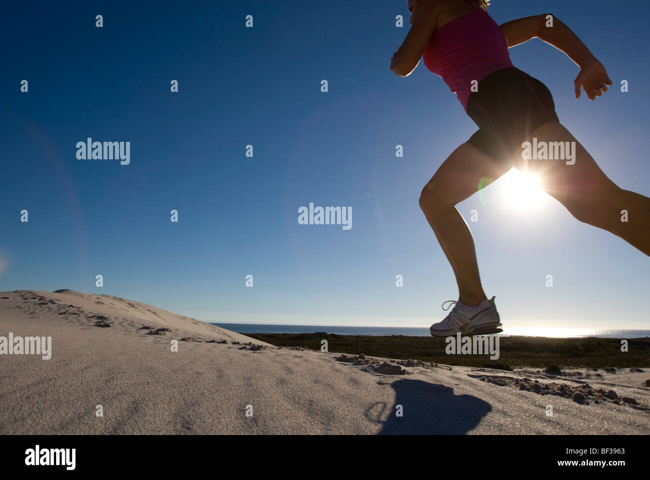 Athlete running on sand dunes hi-res stock photography and images - Alamy