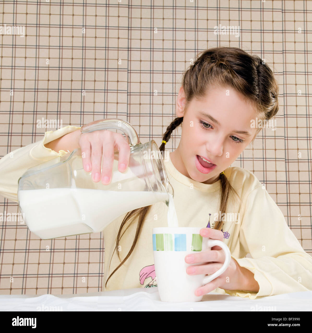 Close-up of a girl pouring milk in a cup Stock Photo - Alamy