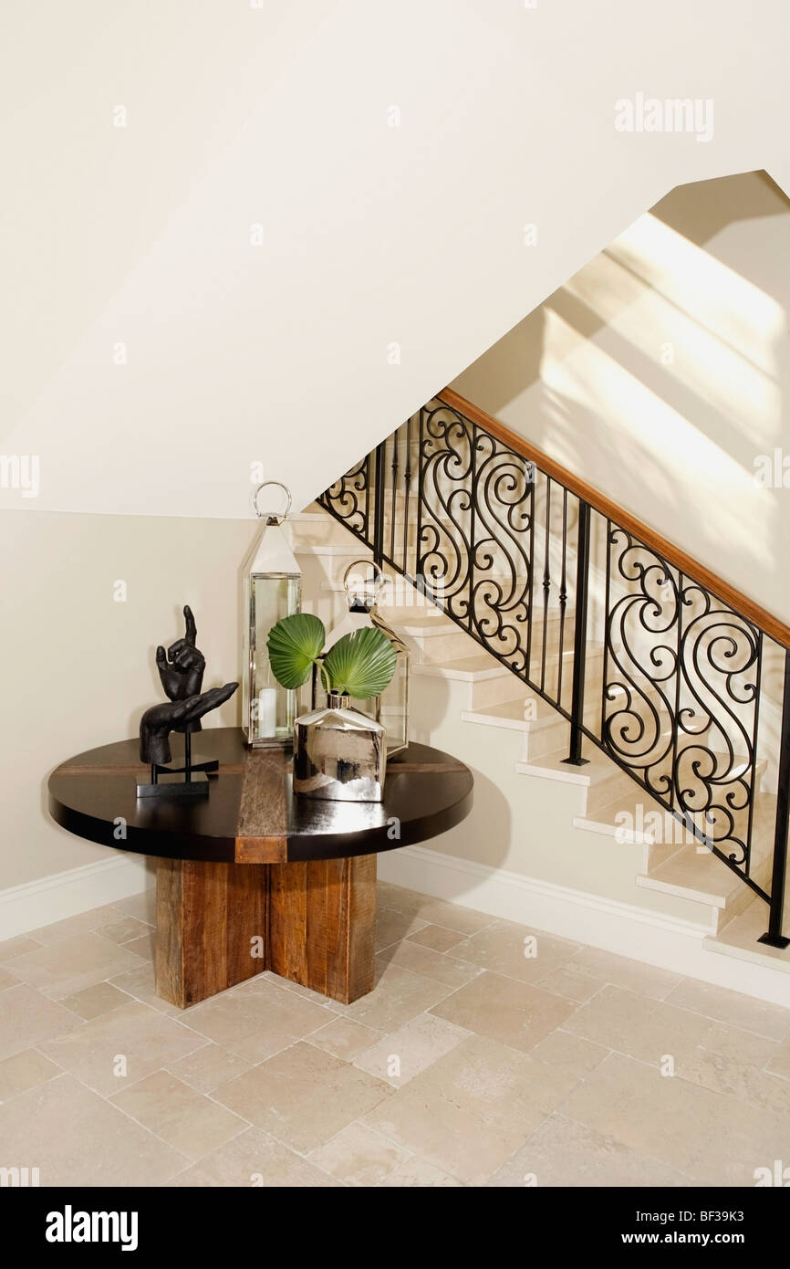 Show pieces on a table under a staircase Stock Photo - Alamy