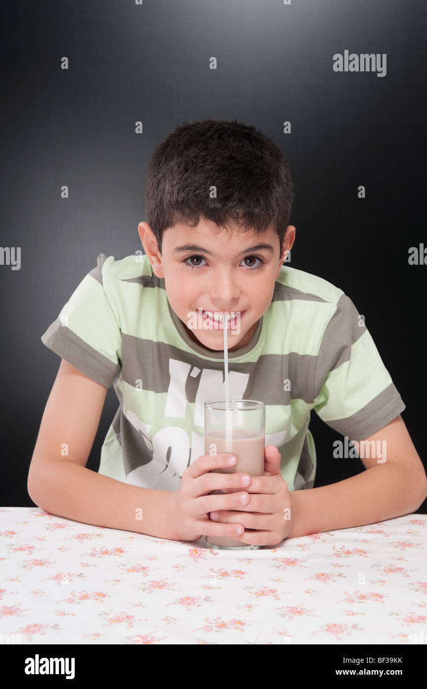 Boy drinking chocolate milkshake and smiling Stock Photo - Alamy