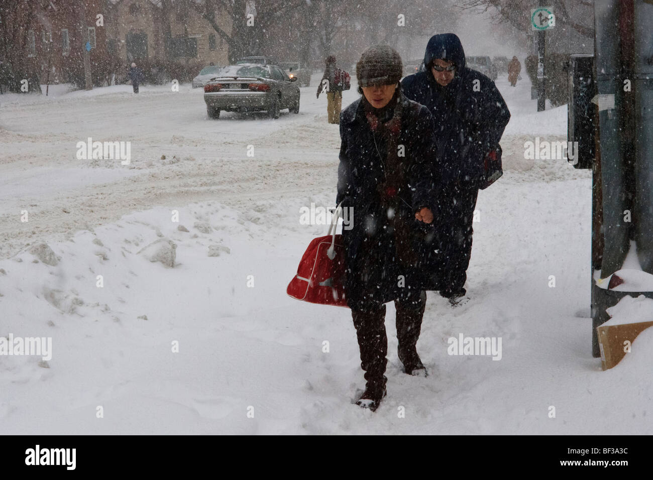 Pedestrians struggle to walk in deep snow on a snow bound Montreal ...