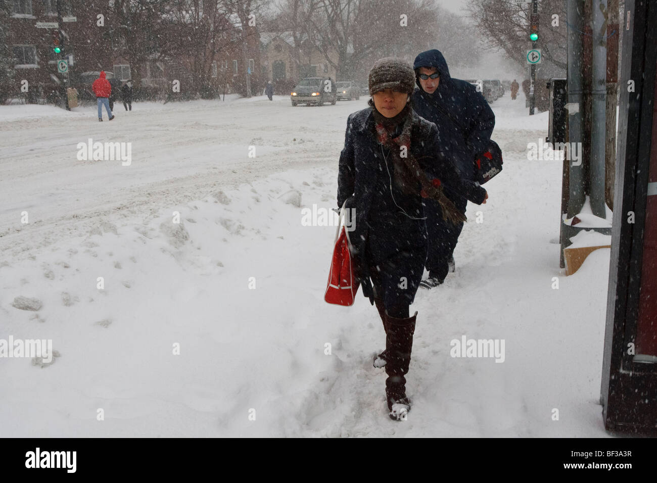 Pedestrians struggle to walk in deep snow on a snow bound Montreal ...