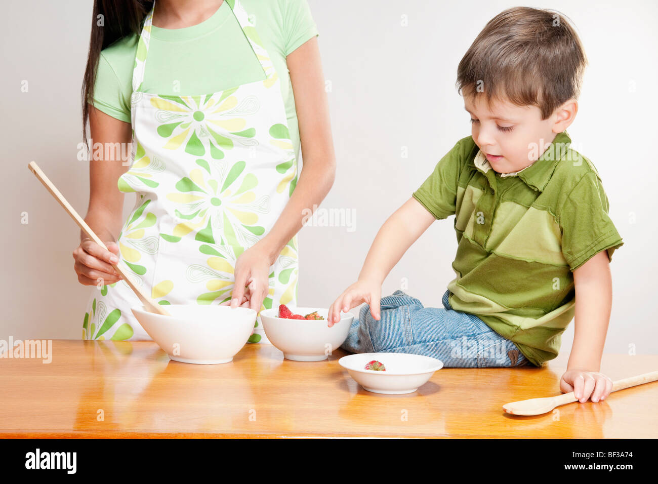 Boy helping his mother in cooking Stock Photo - Alamy