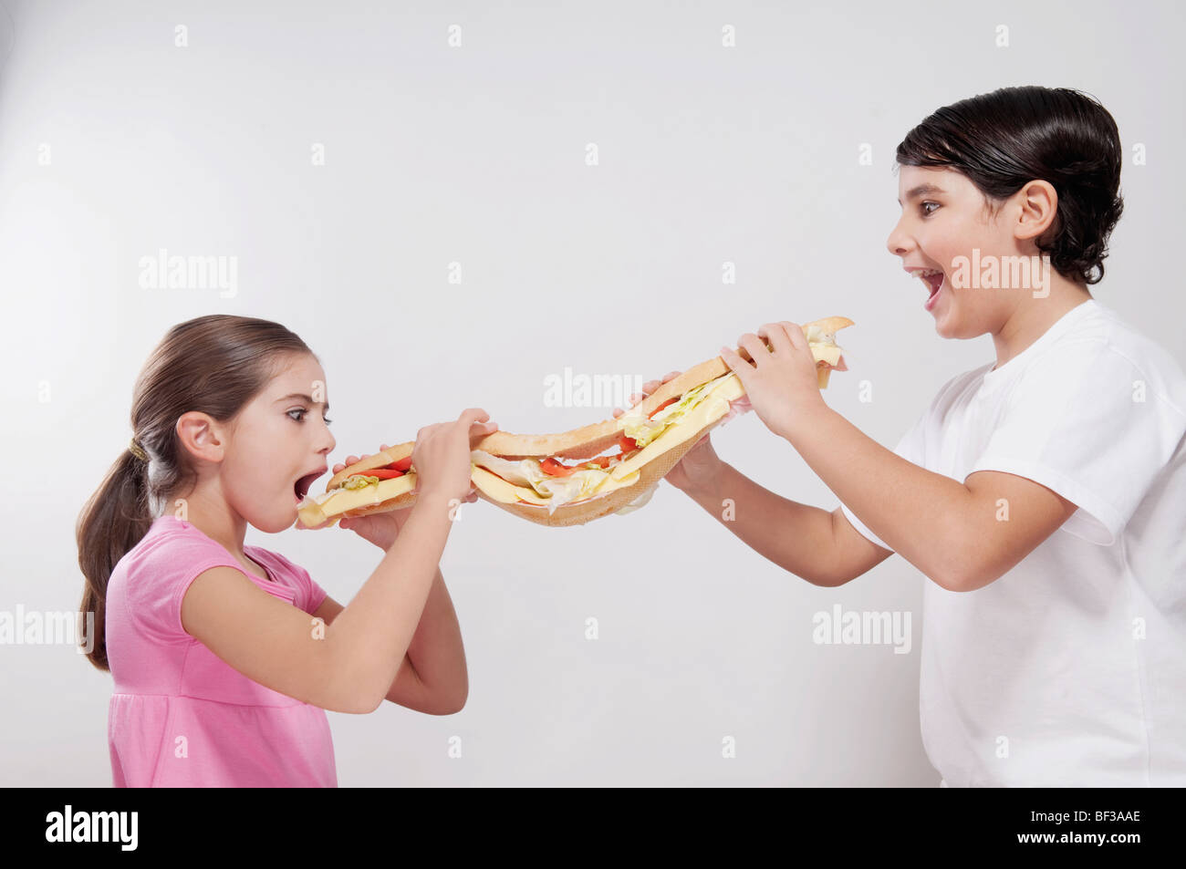 Two children eating submarine sandwich hi-res stock photography and ...