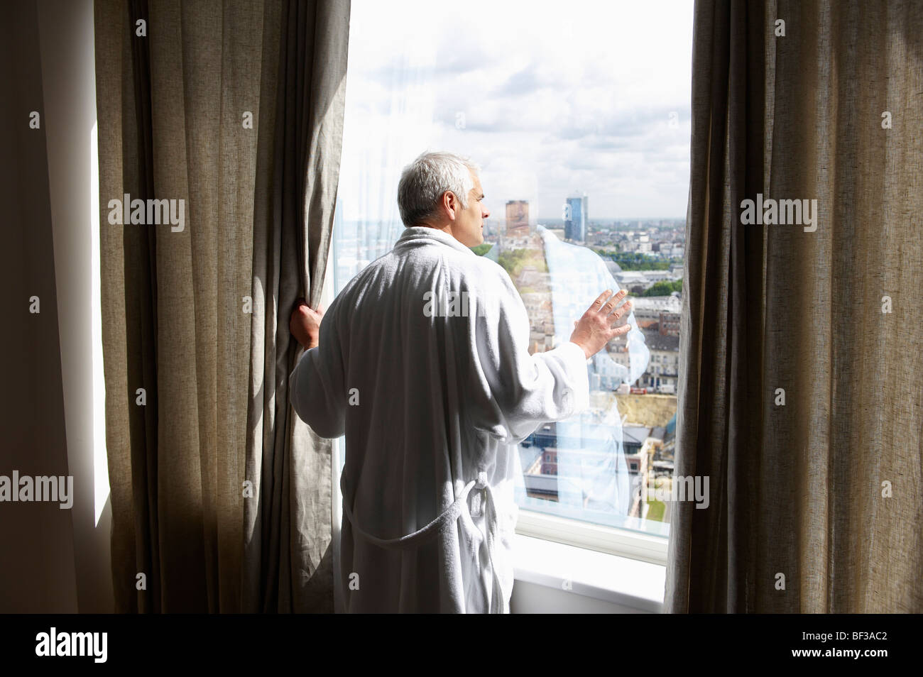 Man looking through the window Stock Photo - Alamy