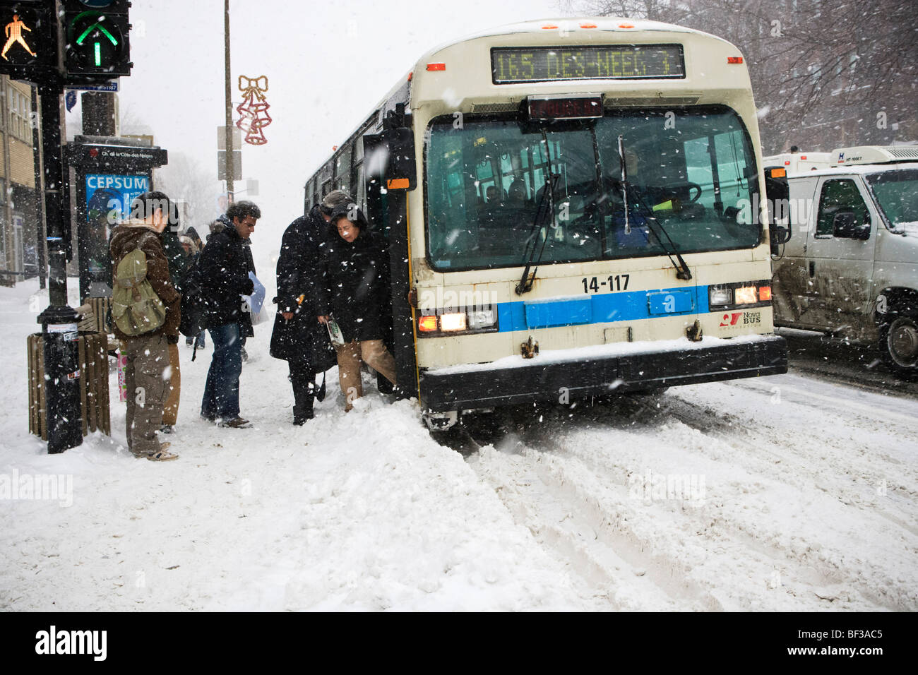 People boarding a bus during a winter snow storm on the plateau in ...