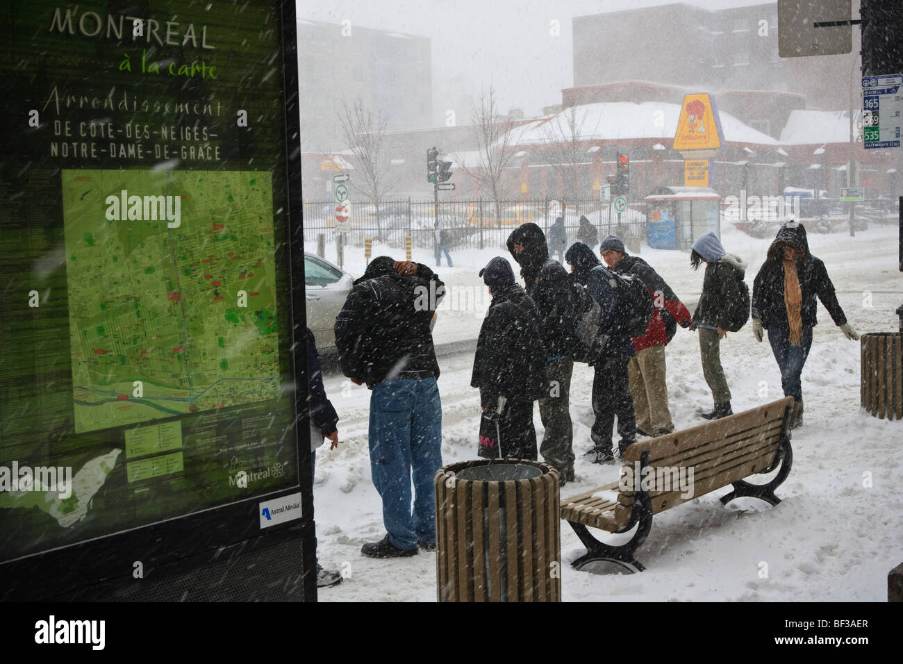 People waiting at a bus stop during a winter snow storm on the plateau ...