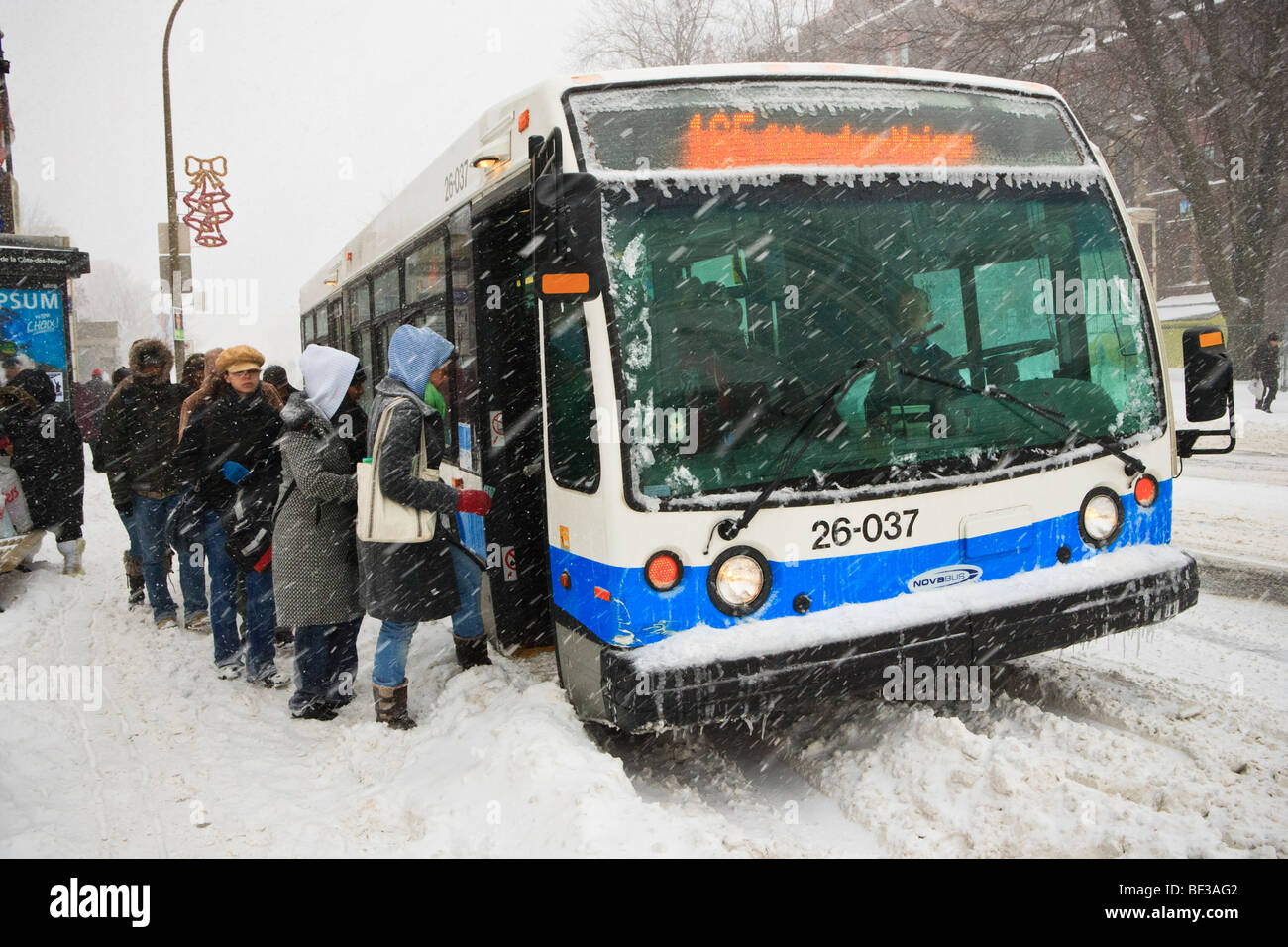 People boarding a bus during a winter snow storm on the plateau in ...