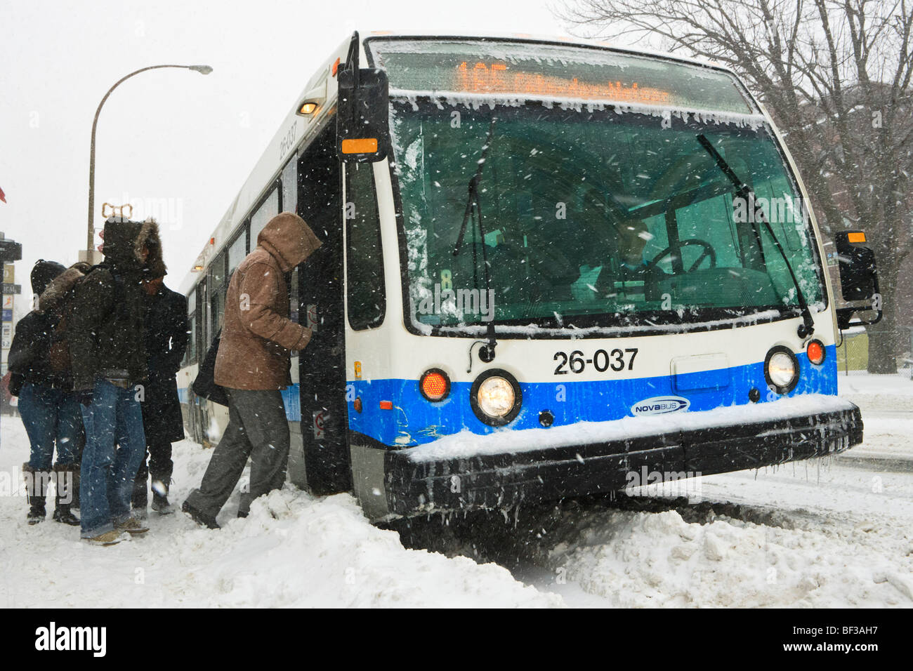 People boarding a bus during a winter snow storm on the plateau in ...