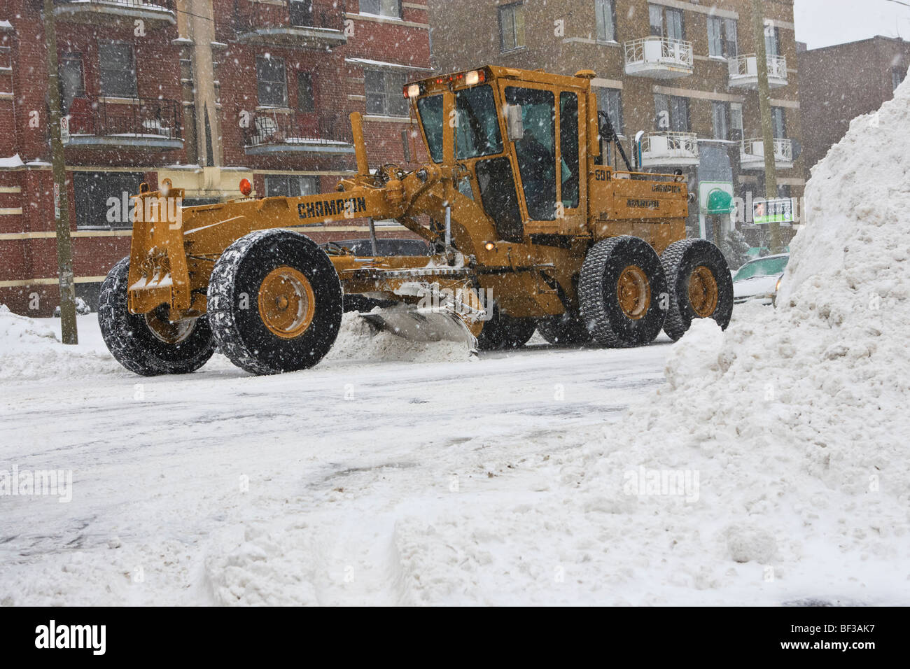 A huge road grader clearing snow on the streets in Montreal Stock Photo ...
