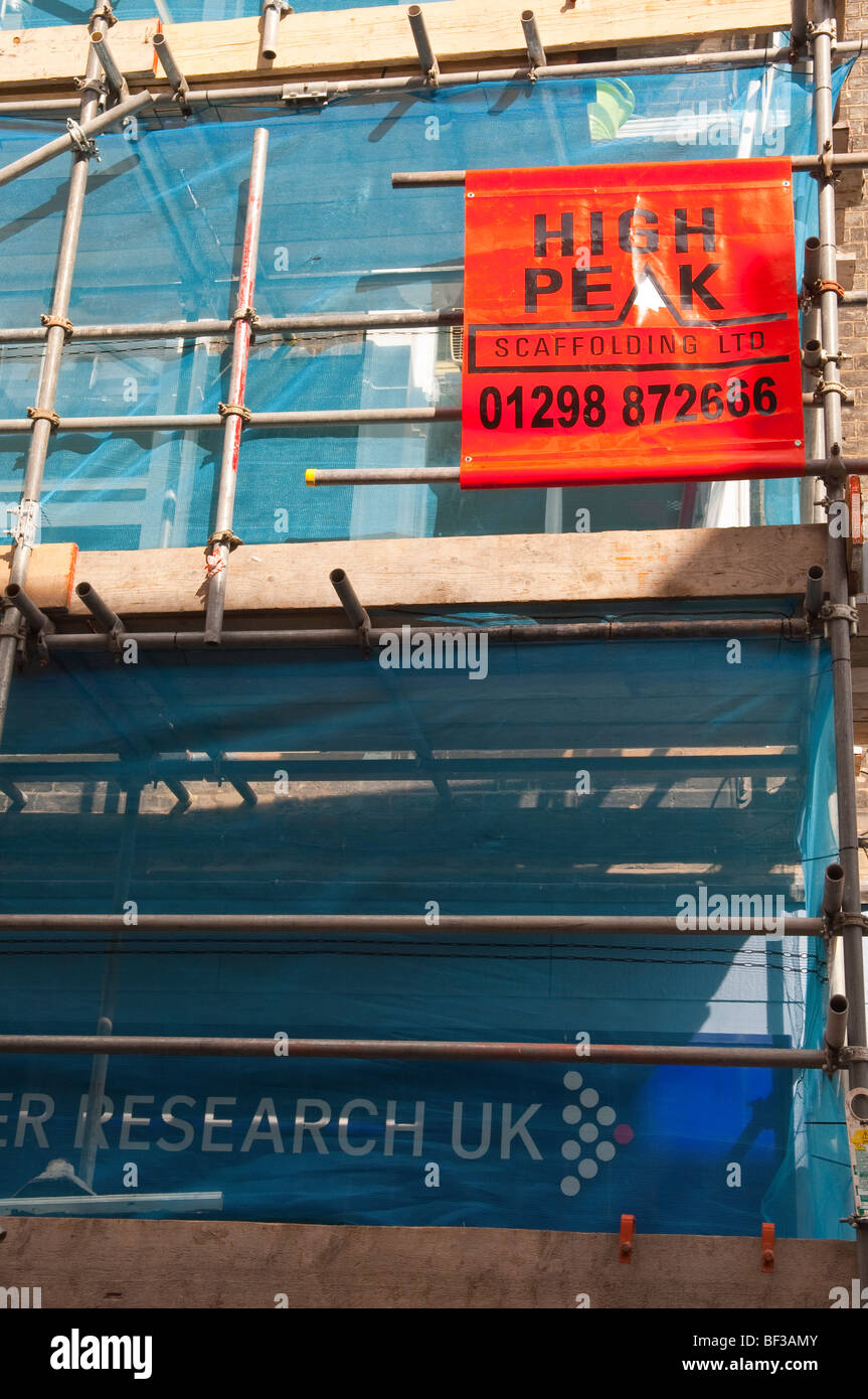 A sign on a construction site advertising high peak scaffolding ltd in ...