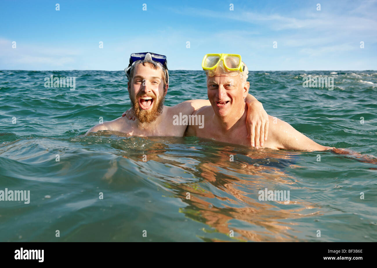 Portrait of two men swimming in sea Stock Photo - Alamy