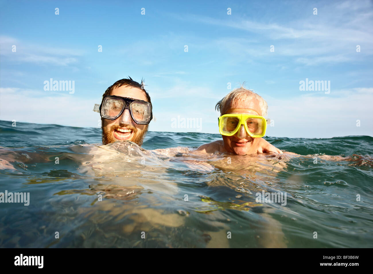 Portrait of two men swimming in sea Stock Photo - Alamy