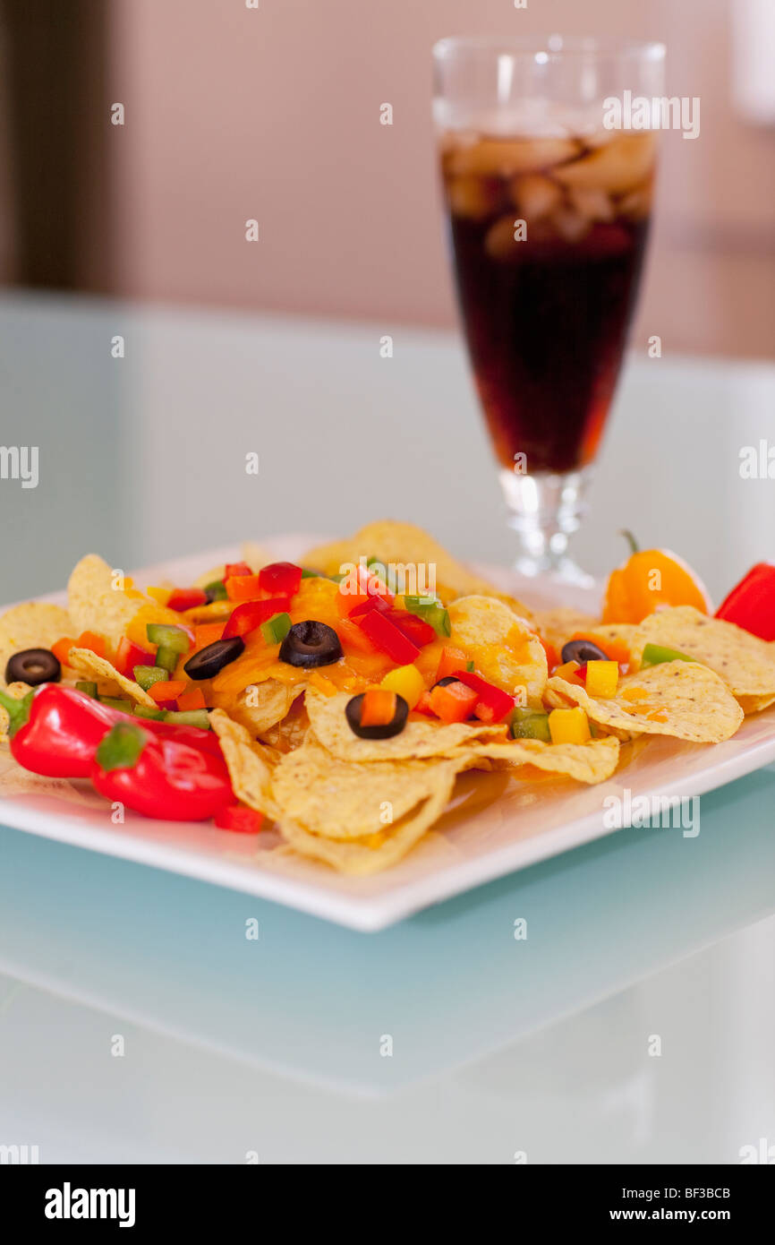 Close-up of chips topped with peppers and olives Stock Photo - Alamy