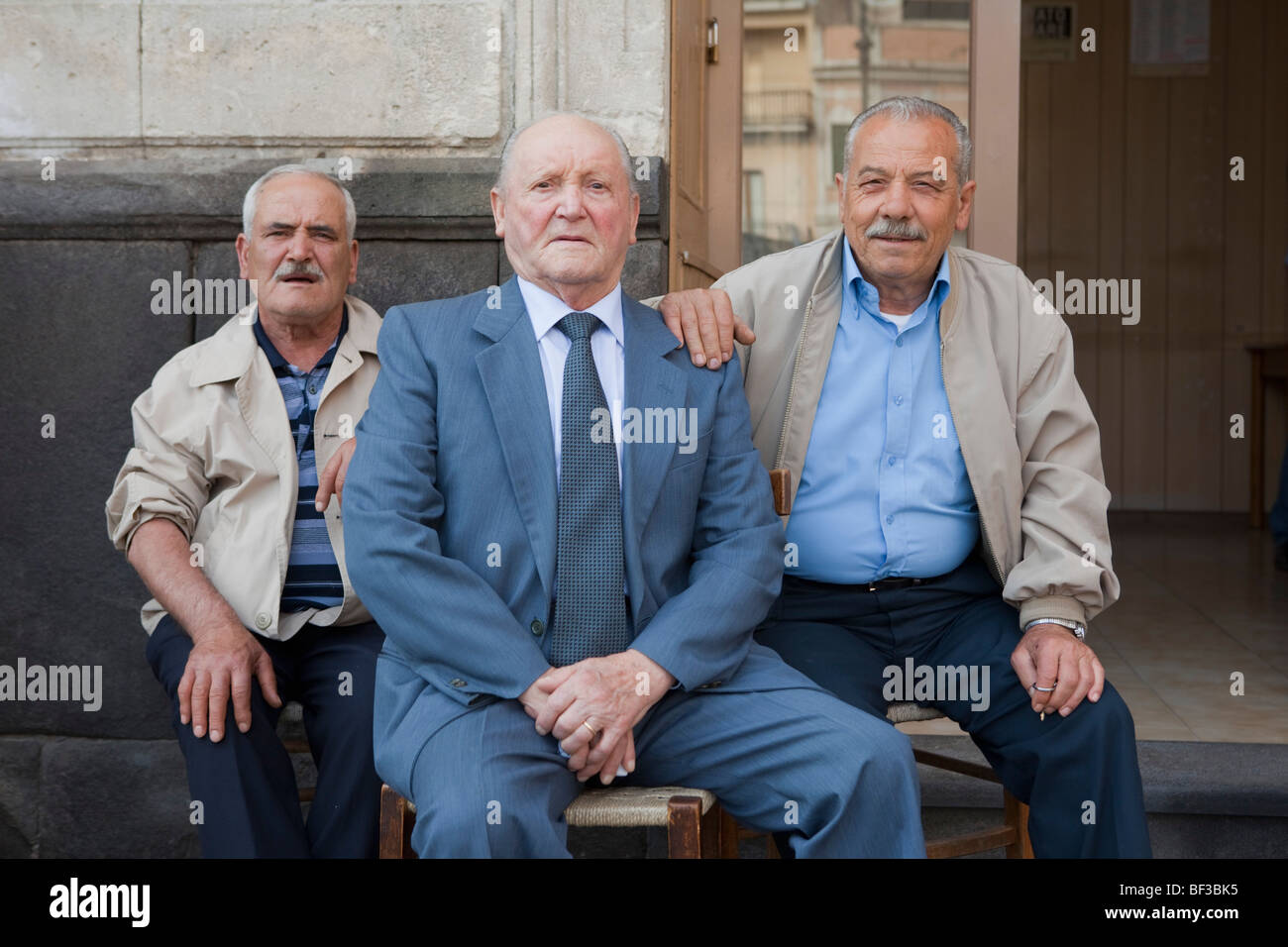 tree old men sitting outside on chairs Stock Photo - Alamy