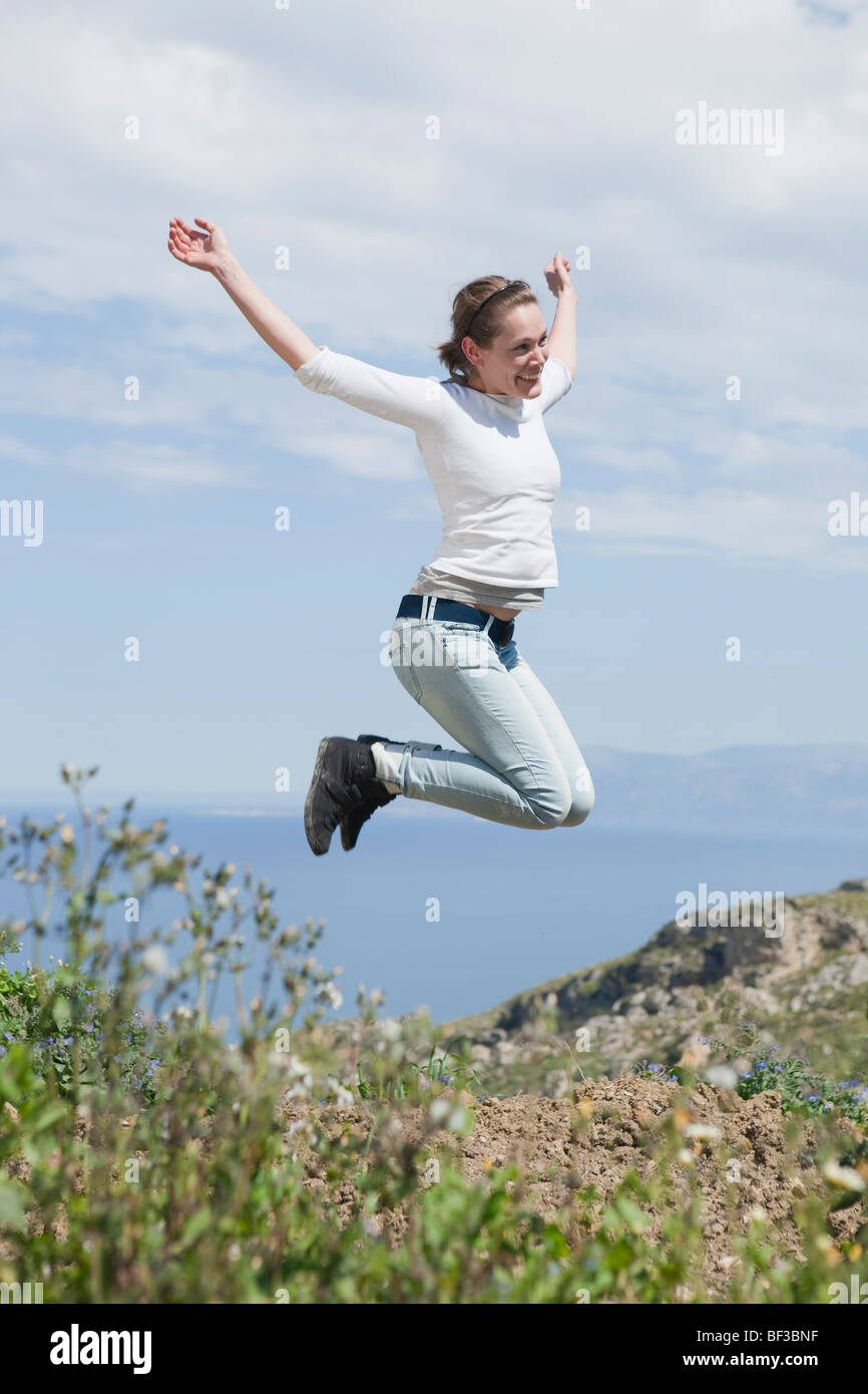 young woman jumping in air Stock Photo - Alamy