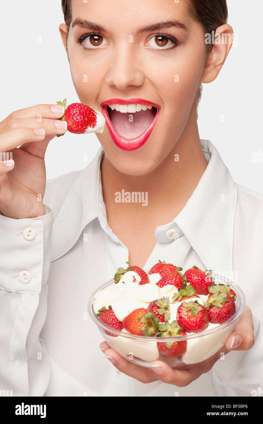 Portrait of a woman eating strawberries in cream Stock Photo - Alamy