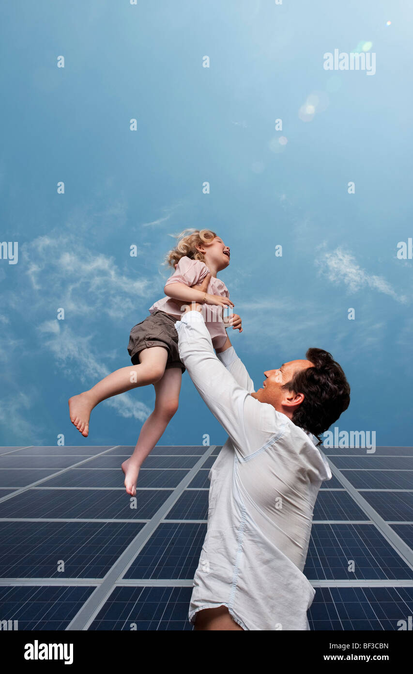 Man and daugther in front of solar panel Stock Photo - Alamy